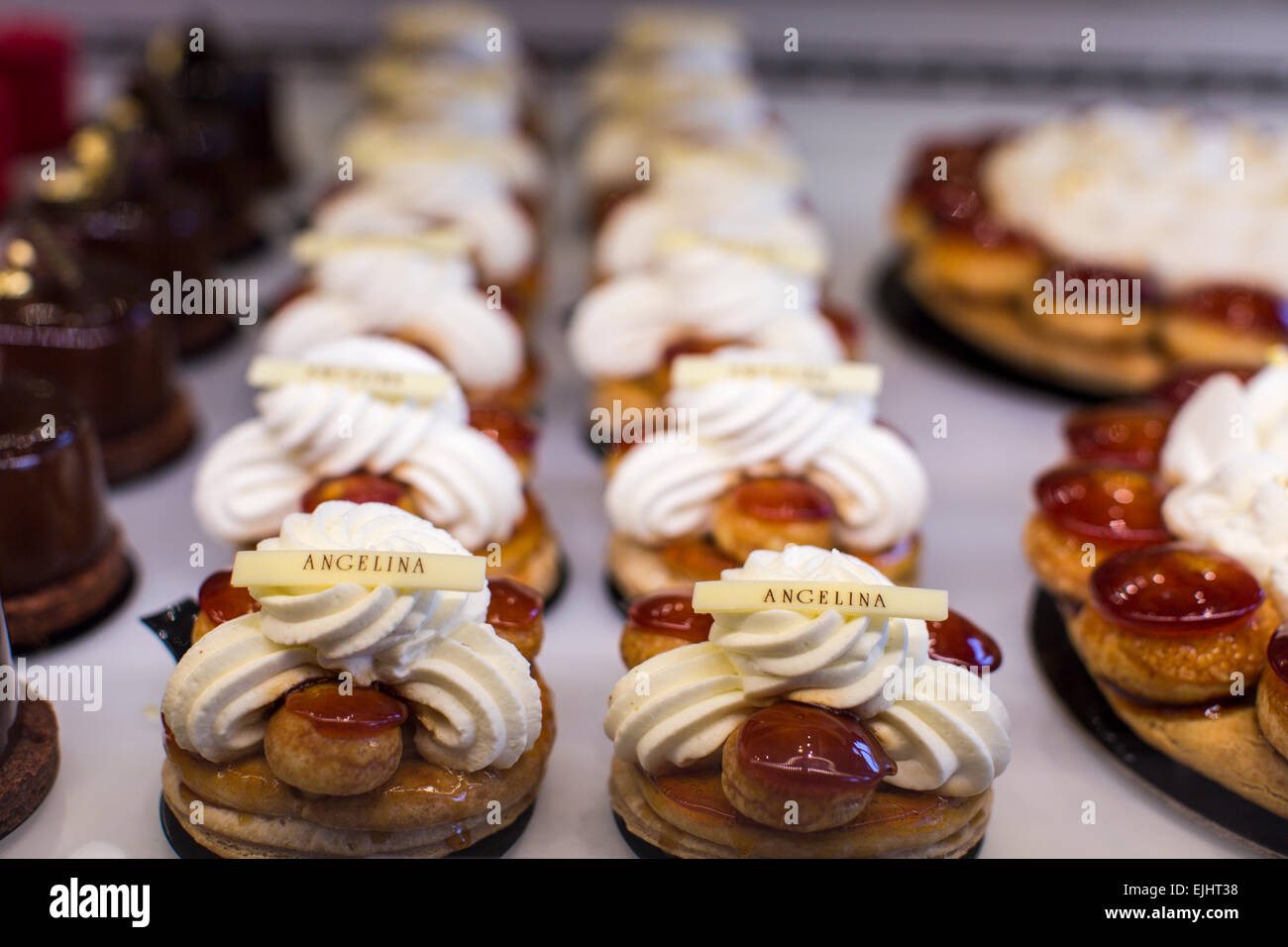 Angelina cakes in display case with signs, Paris, France Stock Photo ...