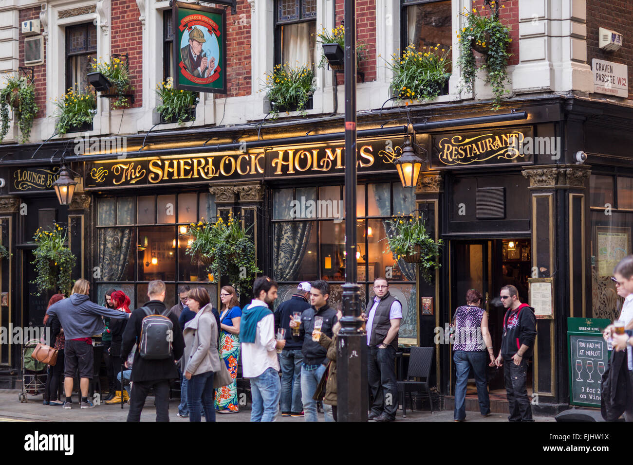 Crowd drinking in street outside the Sherlock Holmes pub in Queen Anne ...