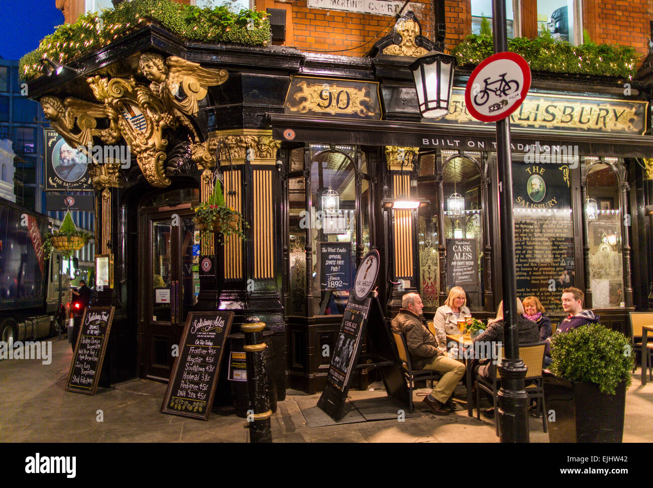 People drinking outside the Salisbury pub at night, London, England ...