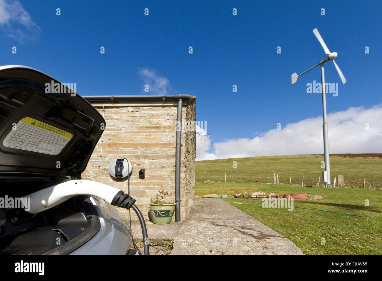 Eco-friendly home and charging electric car Stock Photo - Alamy