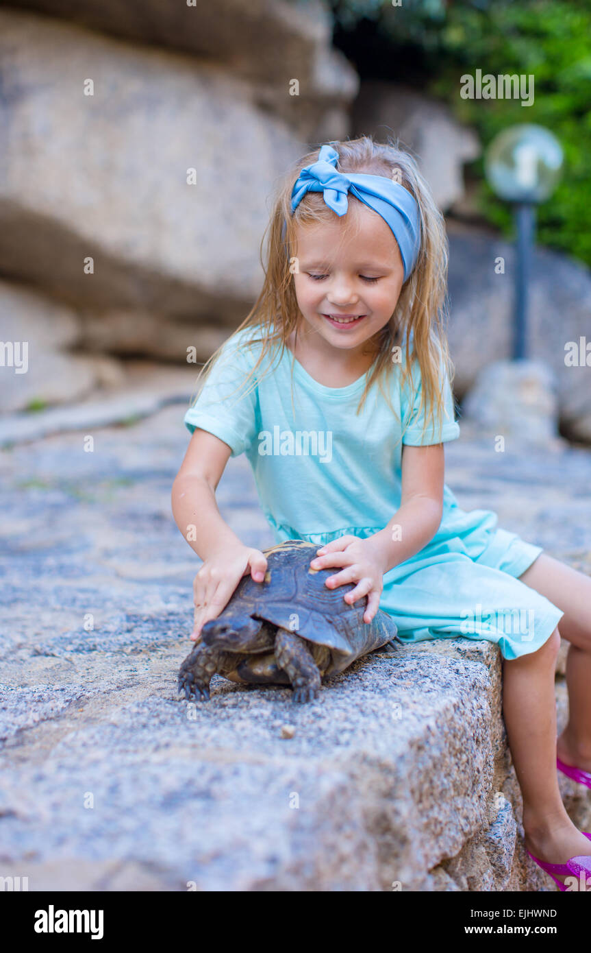 Little adorble happy girl with small turtle outdoors Stock Photo - Alamy