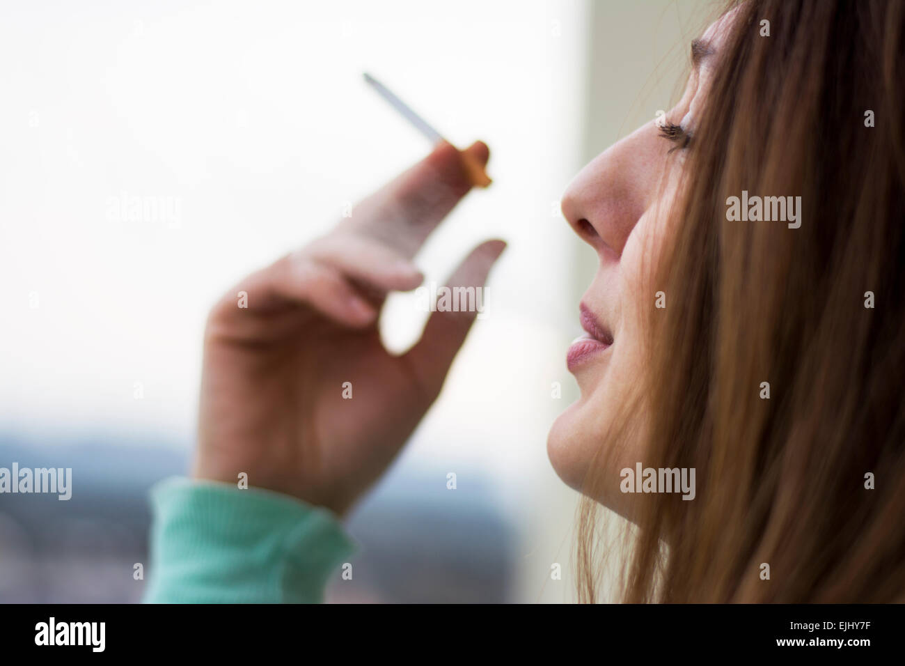 Woman smoking cigarette on hi-res stock photography and images - Alamy
