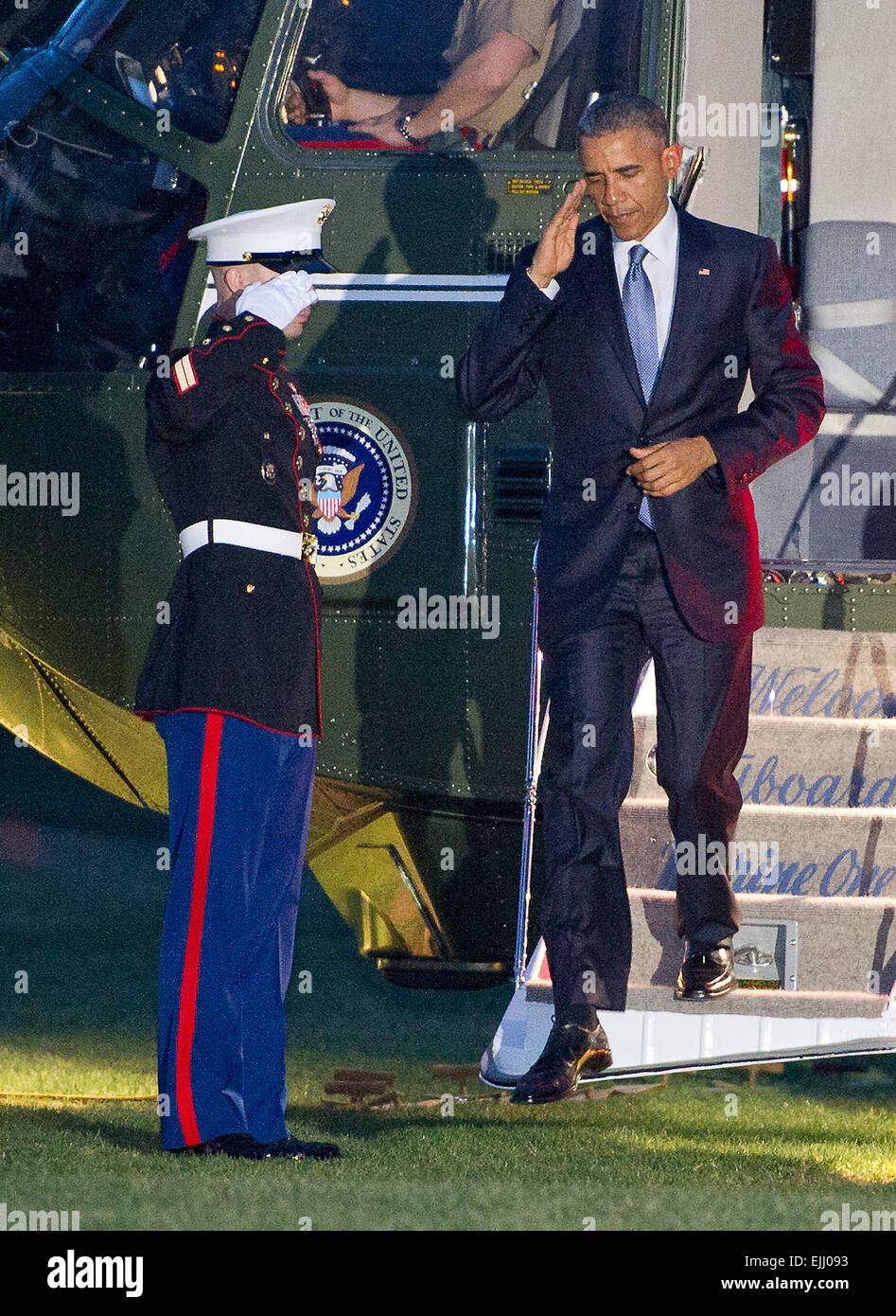 United States President Barack Obama salutes the Marine Guard as he ...