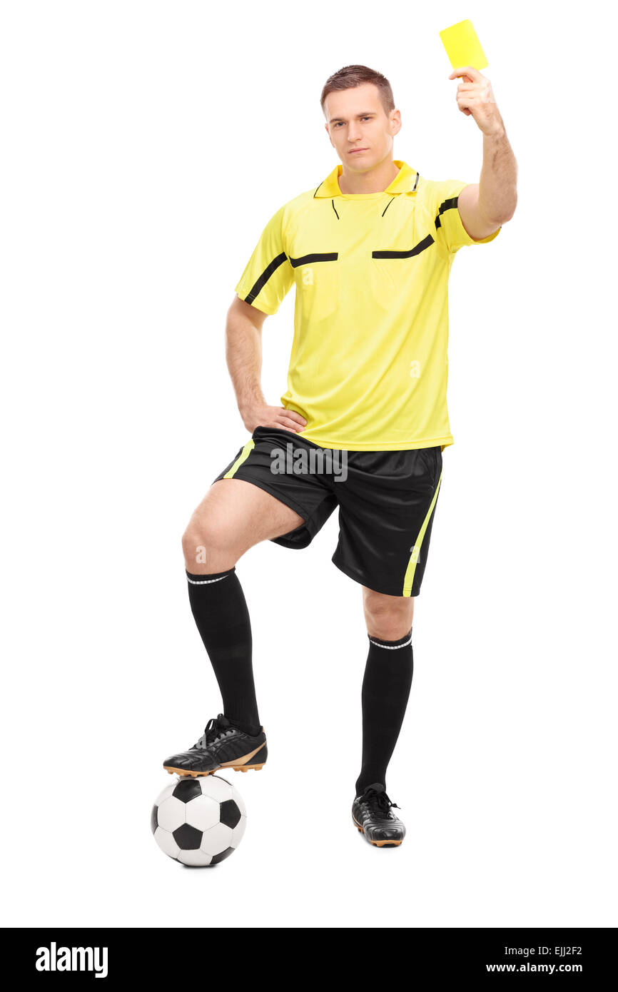 Full length portrait of a young football referee standing over a ...