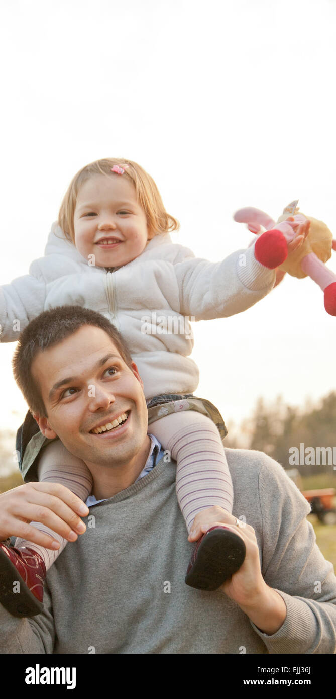 happy daughter with a smiling father shaking dolls into the air Stock ...
