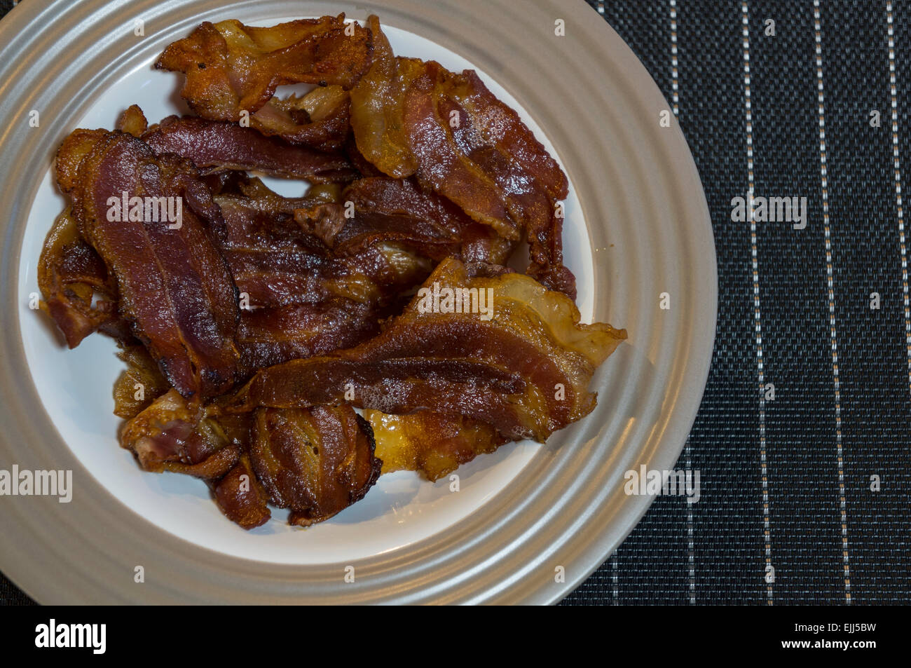 bacon cooked pork oven bake fat pig unhealthy Stock Photo - Alamy