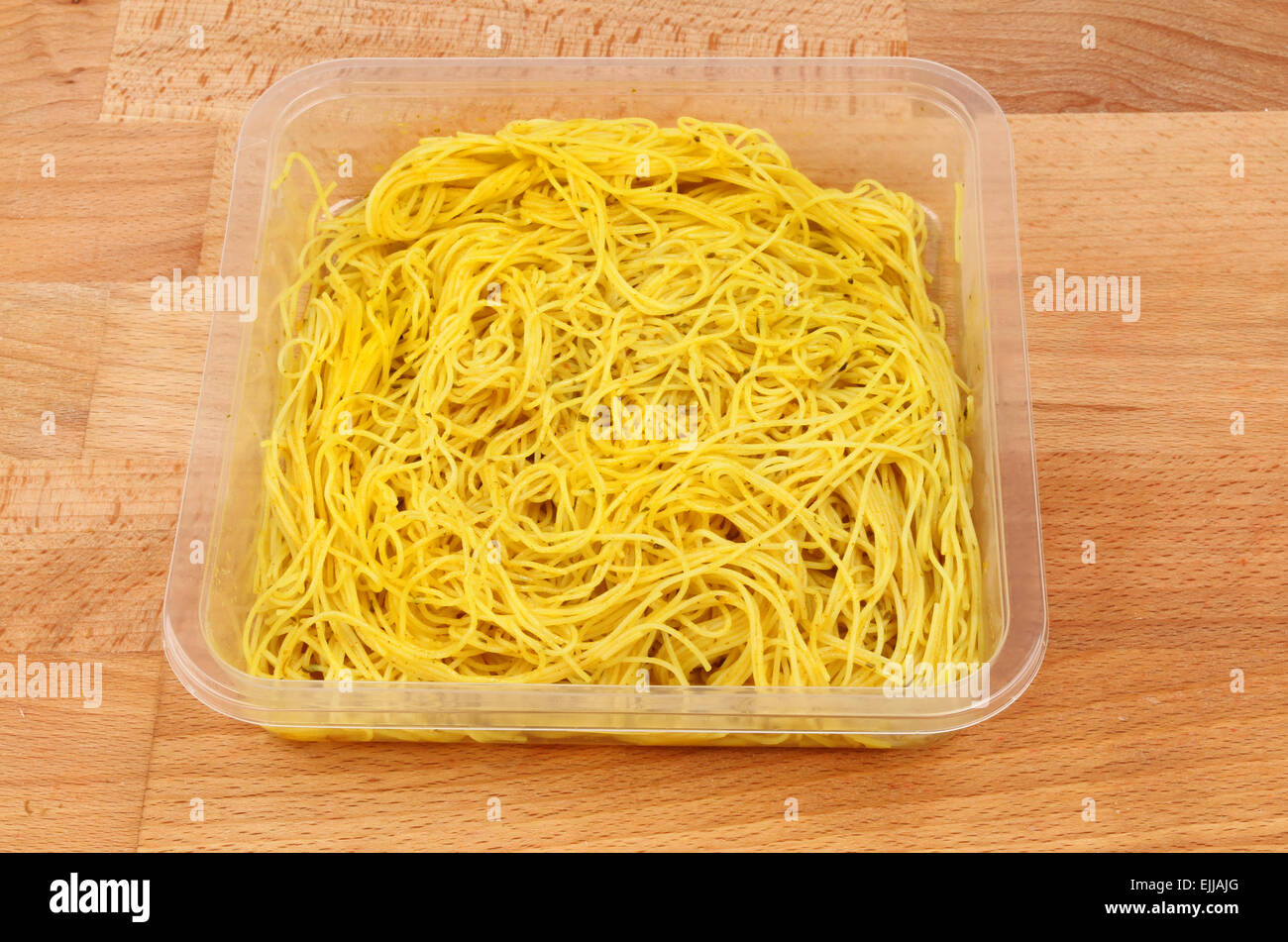 Singapore noodles in a plastic tray on a wooden board Stock Photo - Alamy