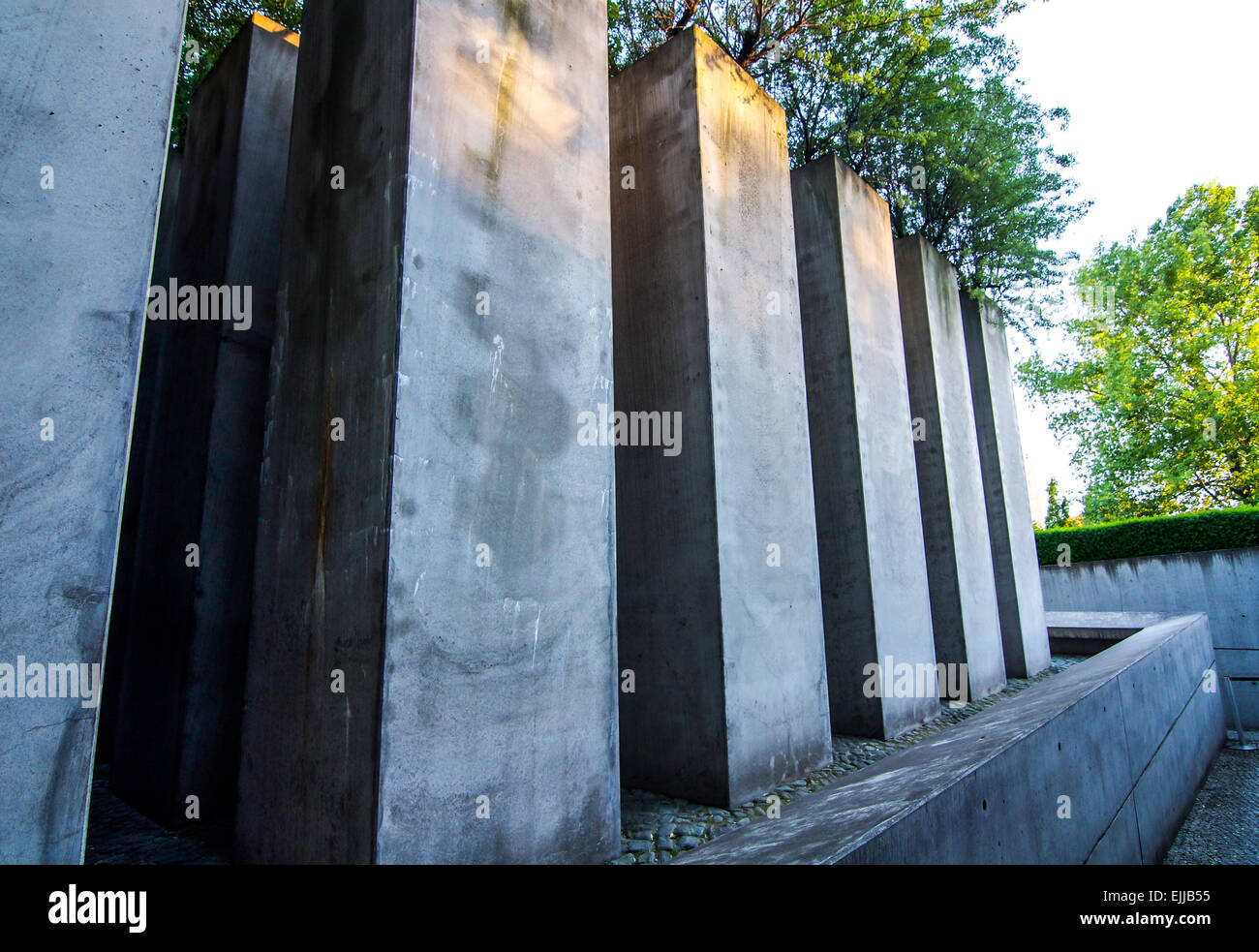 49 concrete columns filled with earth, standing on a sloping piece of ...