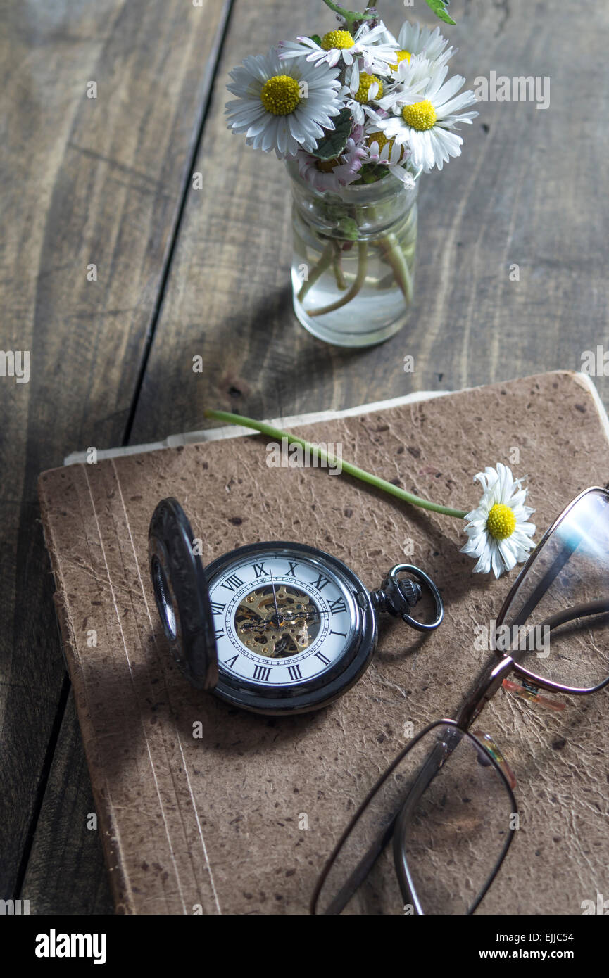 old book and watch on wooden table Stock Photo - Alamy