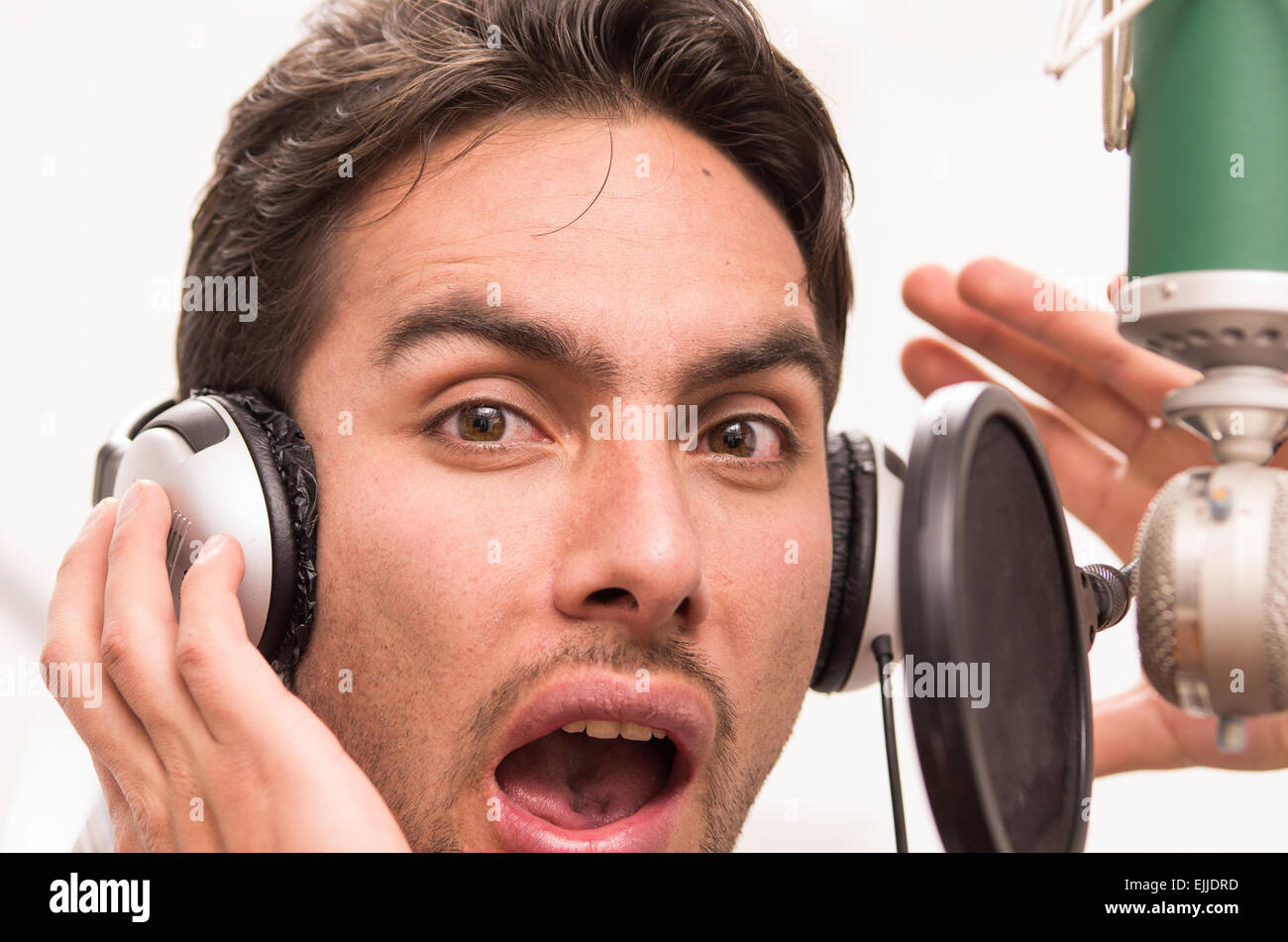 handsome man singing in music studio Stock Photo - Alamy