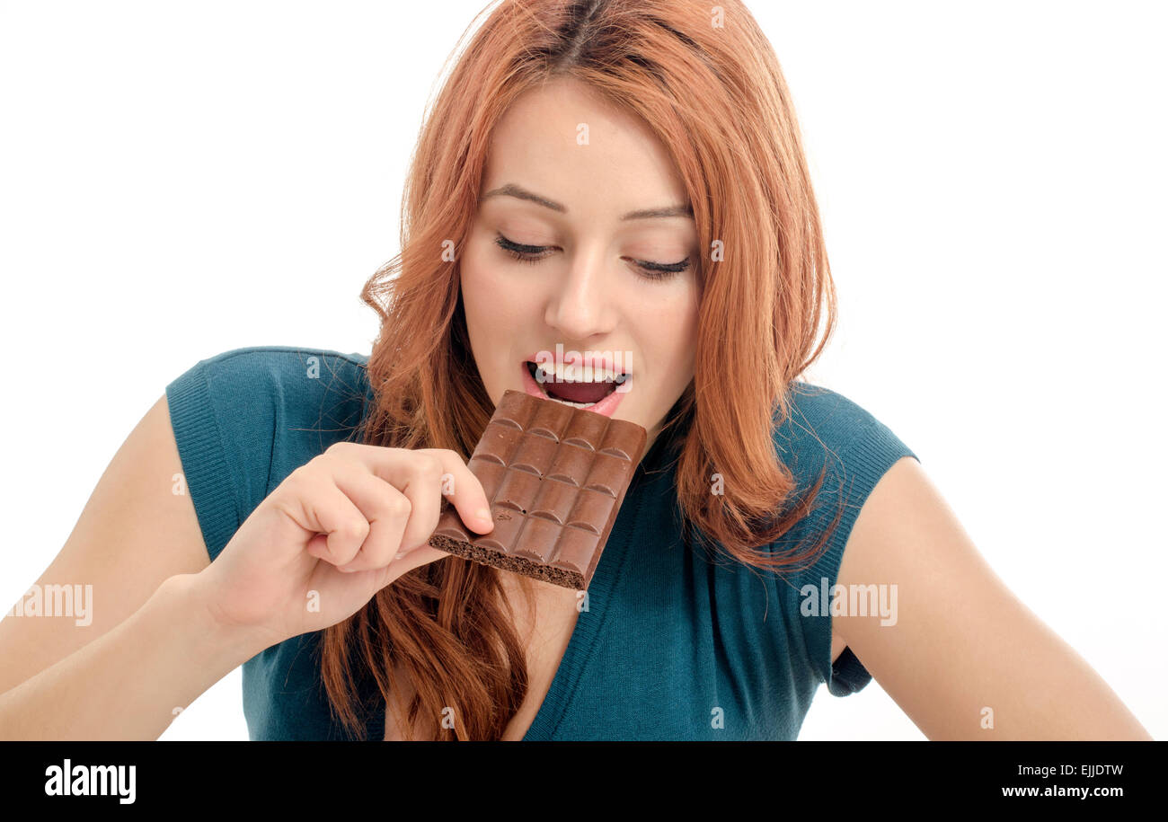 Happy woman eating a yummy chocolate and having some sugar for an ...