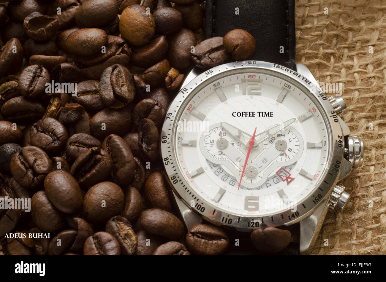 Silver watch with black leather belt and coffee beans on canvas Stock ...