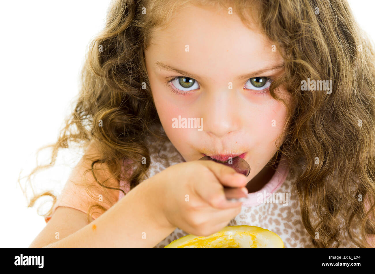 Cute little preschooler girl holding a passion fruit half Stock Photo ...