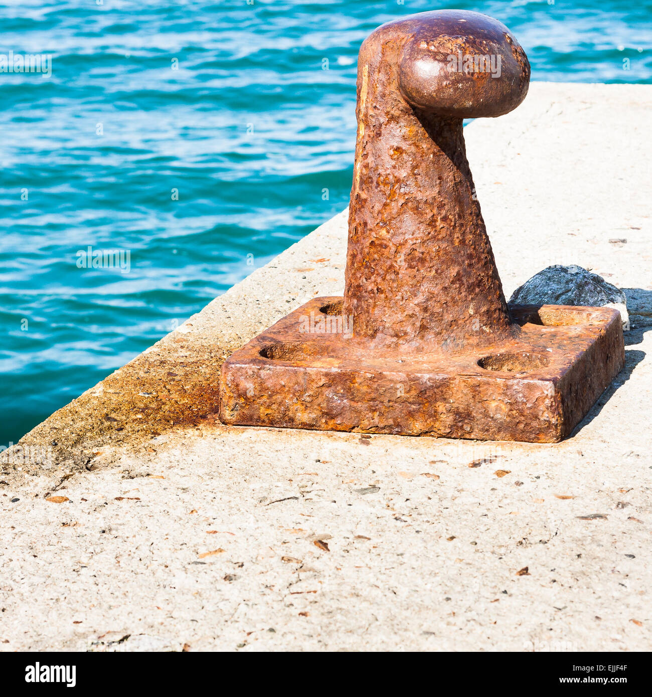 Rusty bollard for mooring boats Stock Photo - Alamy