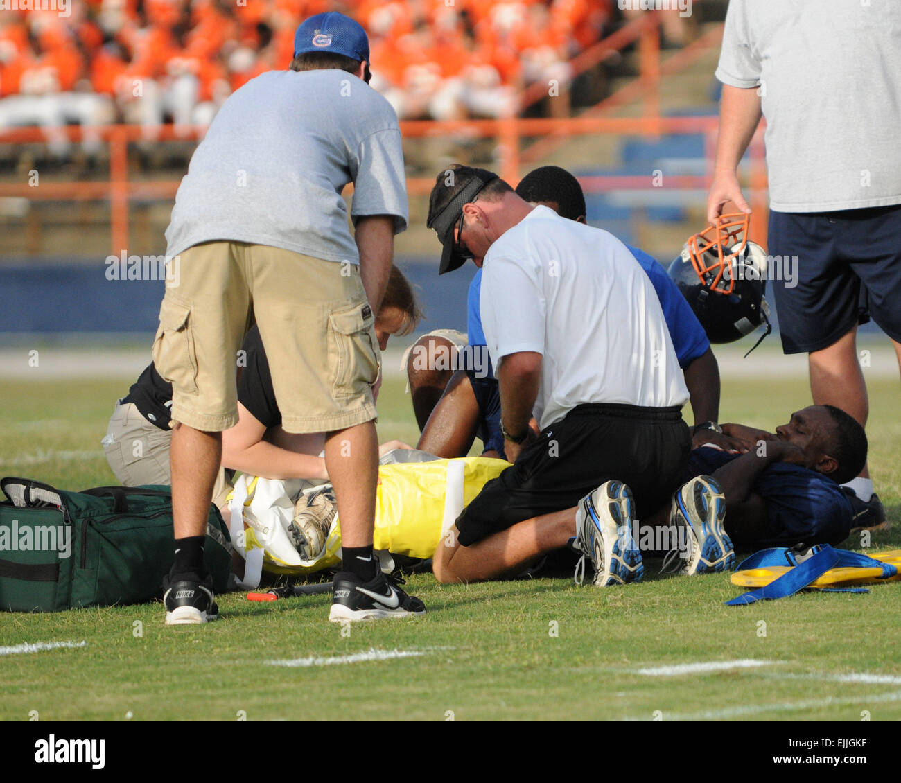 Medical personnel tend to injured player on the football field Stock ...