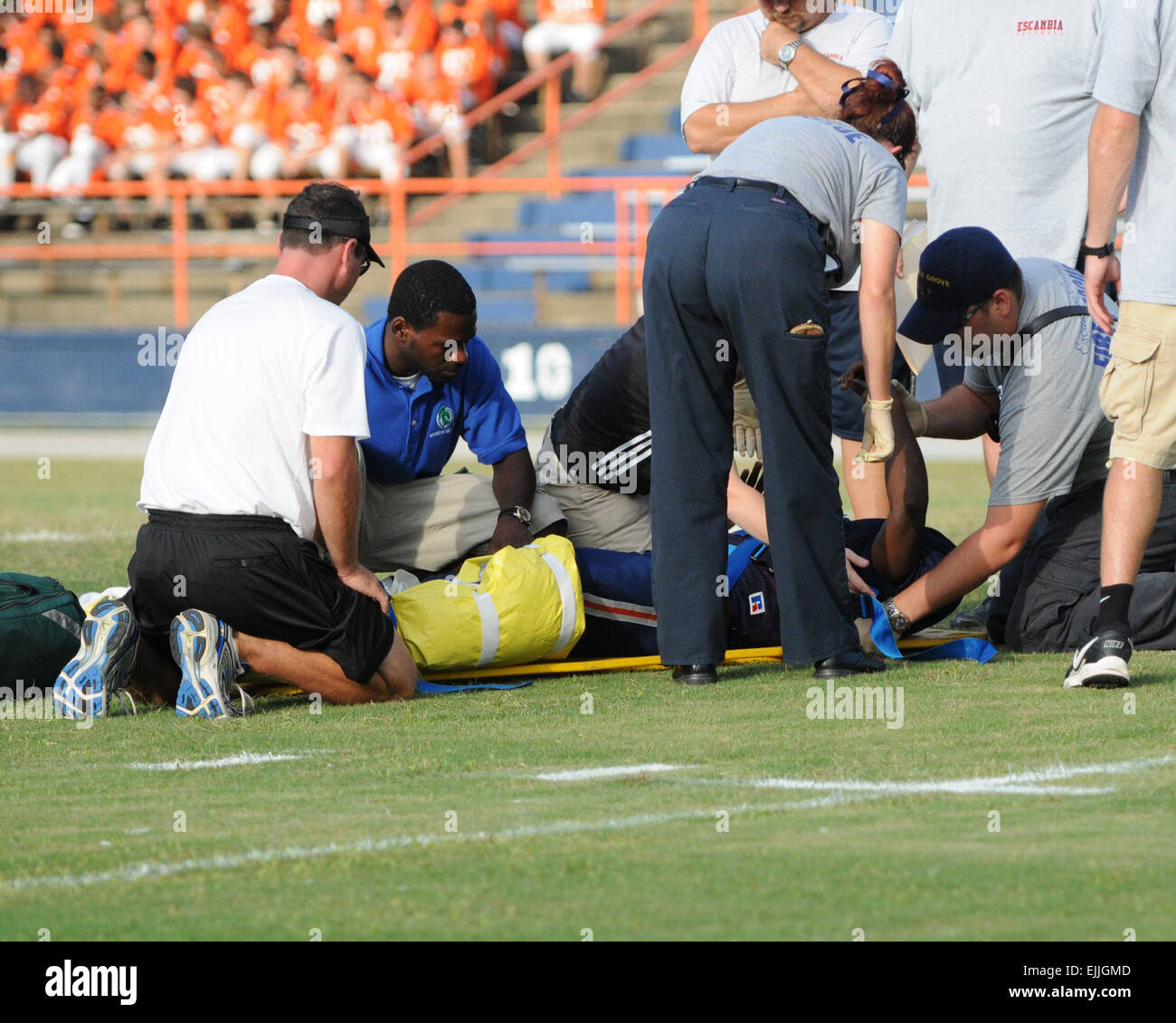 Medical personnel tend to injured football player Stock Photo - Alamy