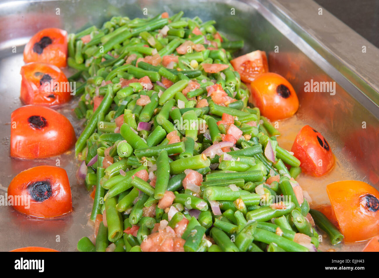 Green runner beans and carrot with tomatoes on display at a hotel ...