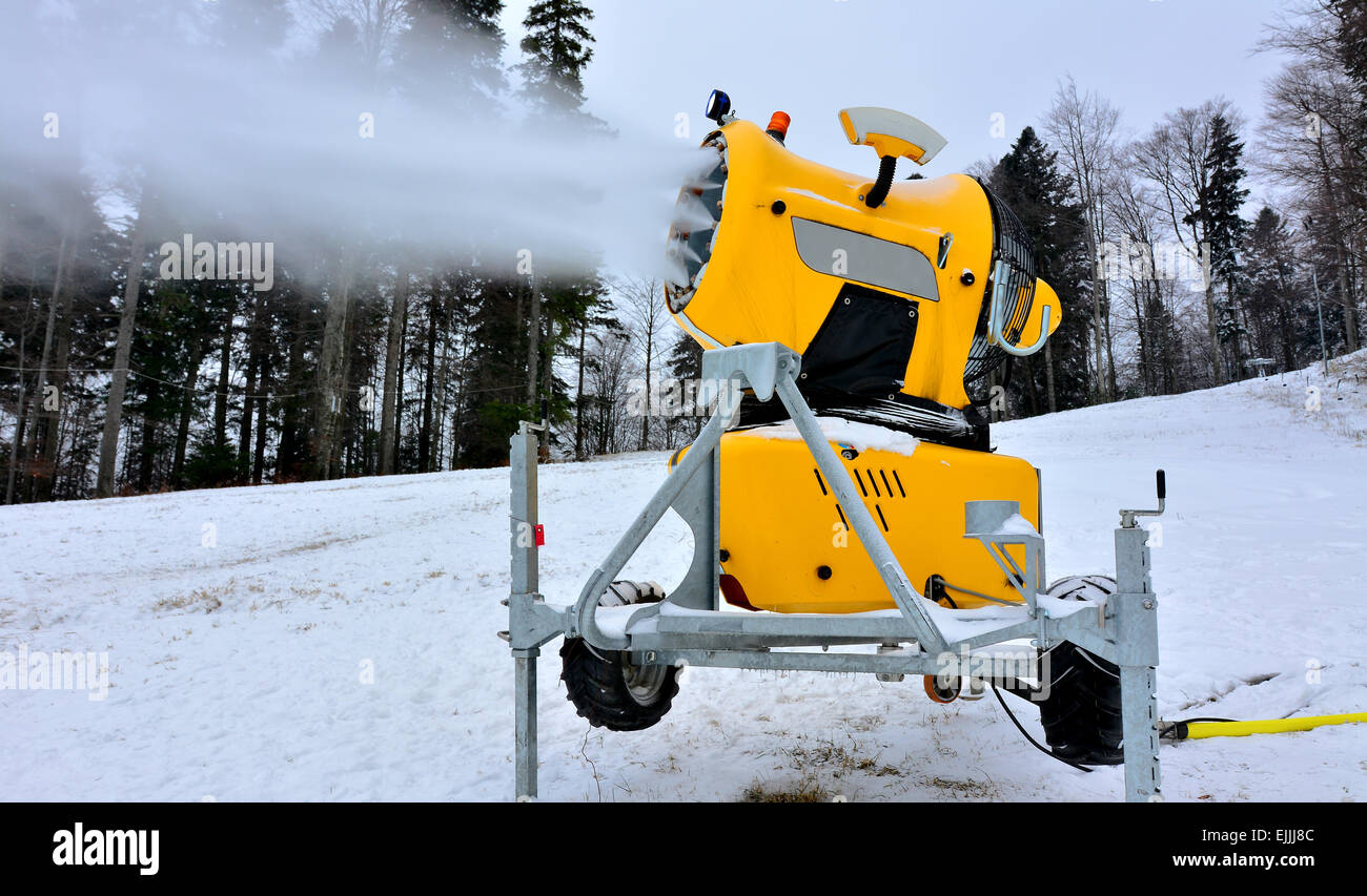Yellow snow cannon on ski slope Stock Photo - Alamy
