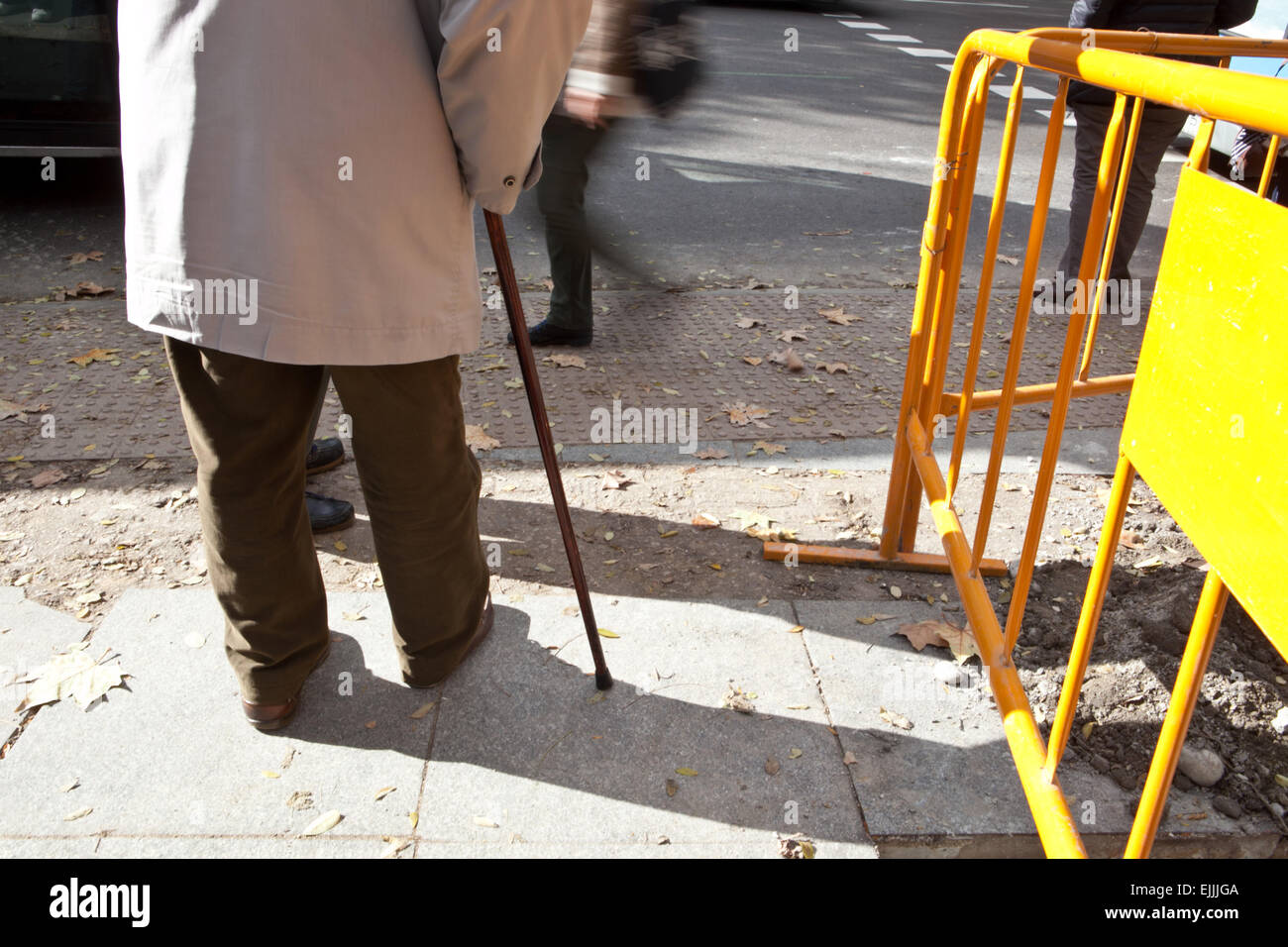 Elder man avoiding an construction fence in the city street Stock Photo ...