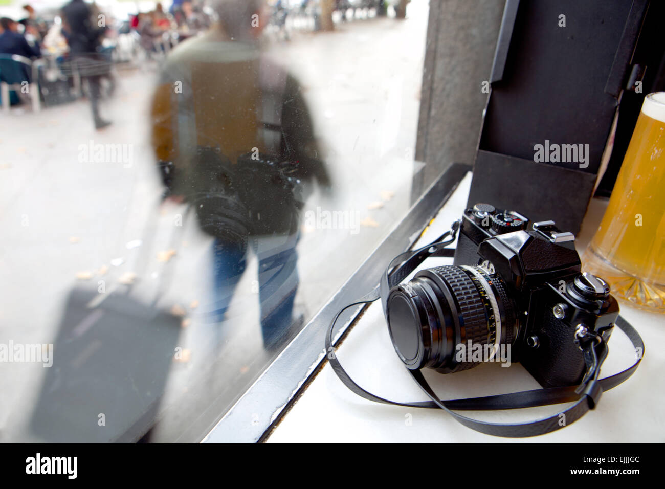 Vintage reflex film camera on table beside the window of a bar Stock ...