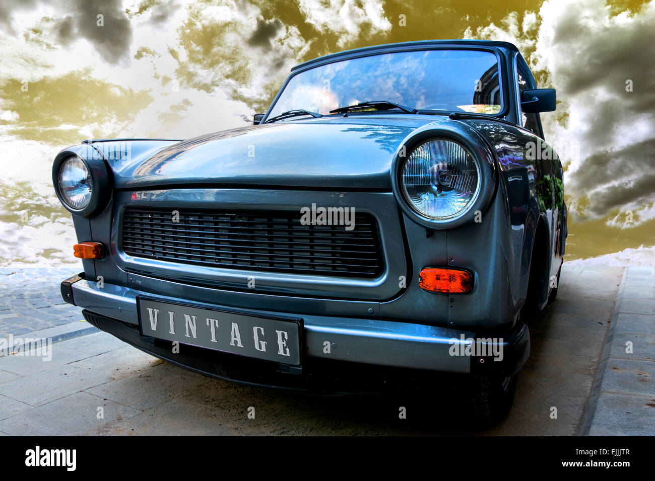 Grey blue vintage german car with dark yellow sky background Stock ...