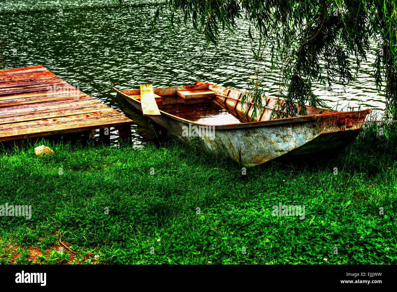 Boat at shore of lake, by the pontoon Stock Photo - Alamy