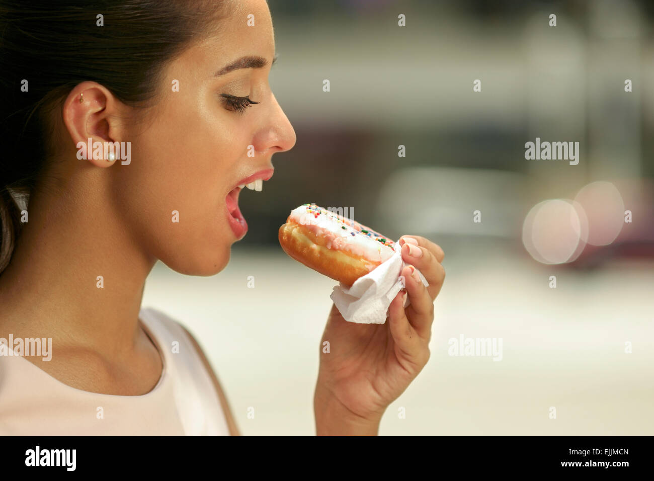 Close up of young hungry business woman with mouth open, doing ...