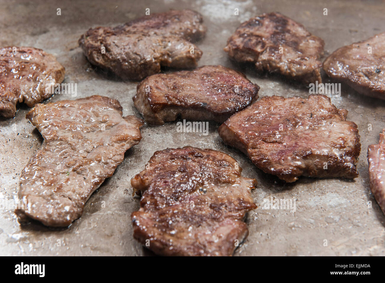 Closeup of beef steaks cooking at a hotel restaurant buffet Stock Photo ...