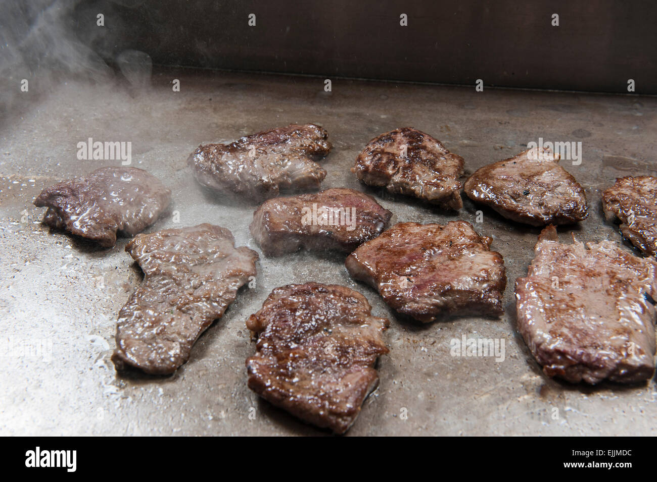 Closeup of beef steaks cooking at a hotel restaurant buffet Stock Photo ...