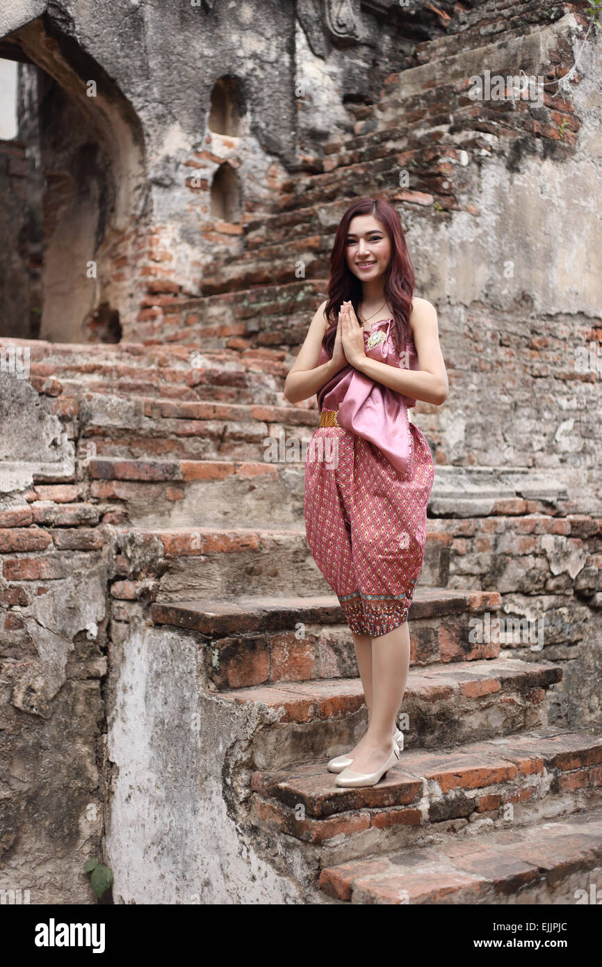 Female pay respect in Thai traditional dress at historical park Stock ...