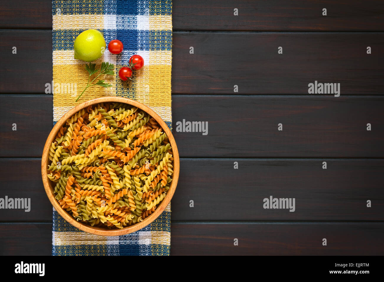 Overhead shot of raw tricolor fusilli or rotini pasta (traditional ...