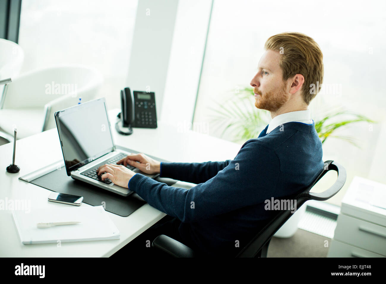 Young man working in the office Stock Photo - Alamy