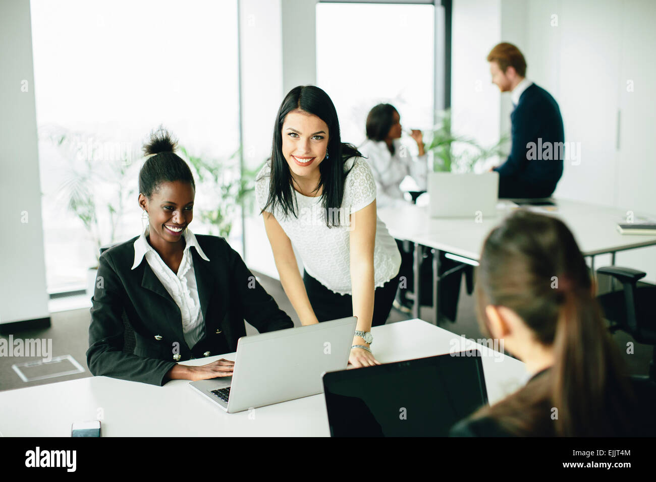 Young women working in the office Stock Photo - Alamy