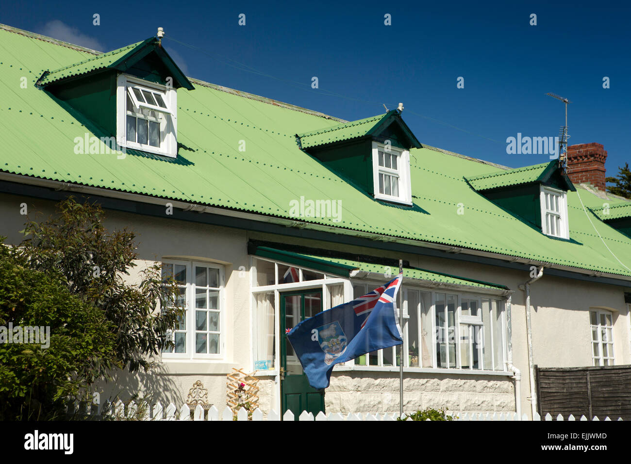 Falklands, Port Stanley, Falkland Islands flag flying outside green ...