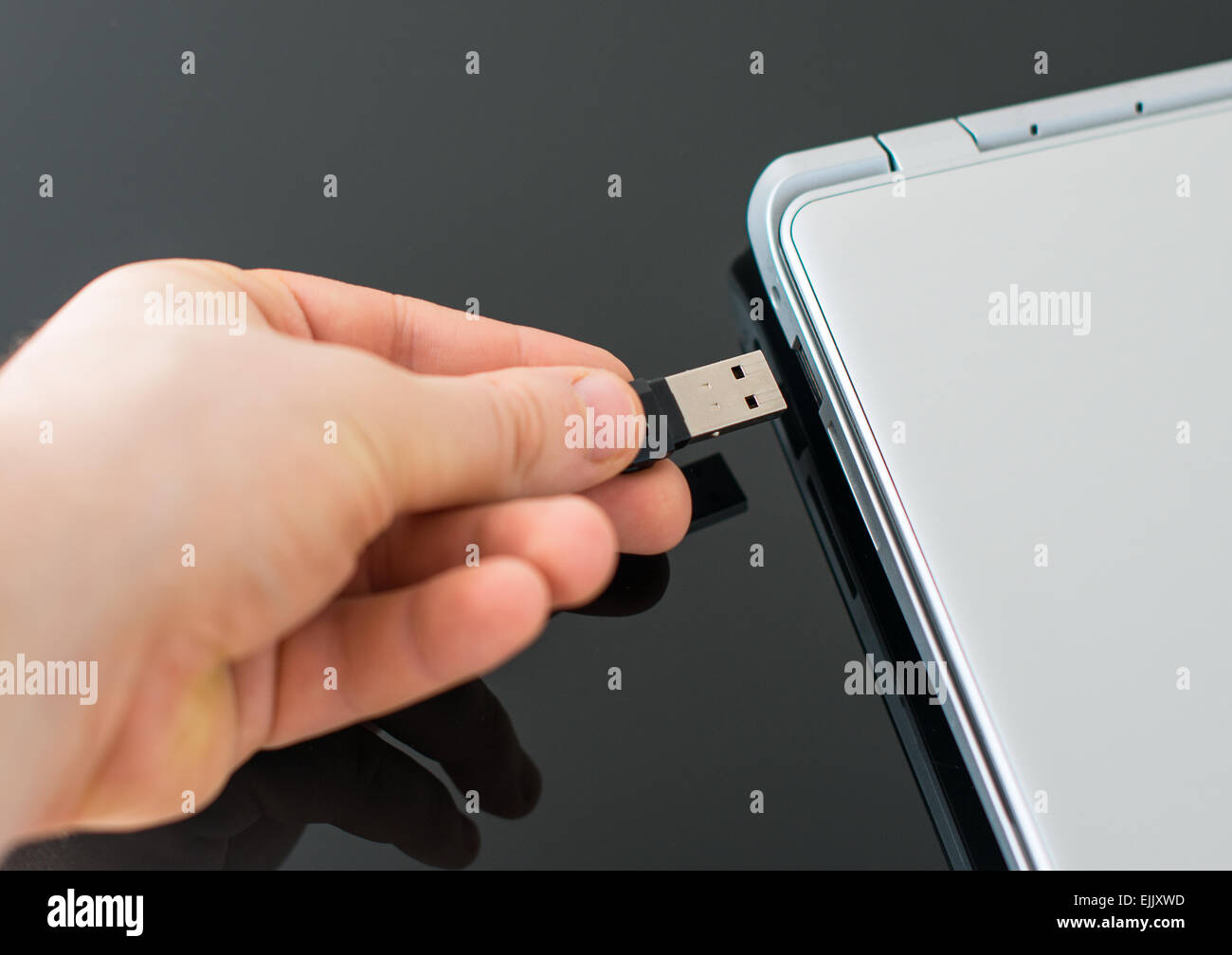 Hand plugging usb flash drive to laptop Stock Photo - Alamy