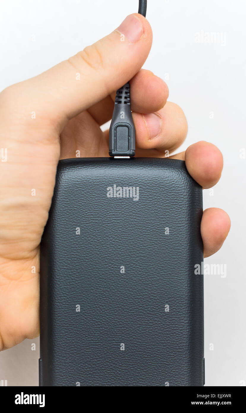 Male hand inserting micro USB to mobile phone Stock Photo - Alamy