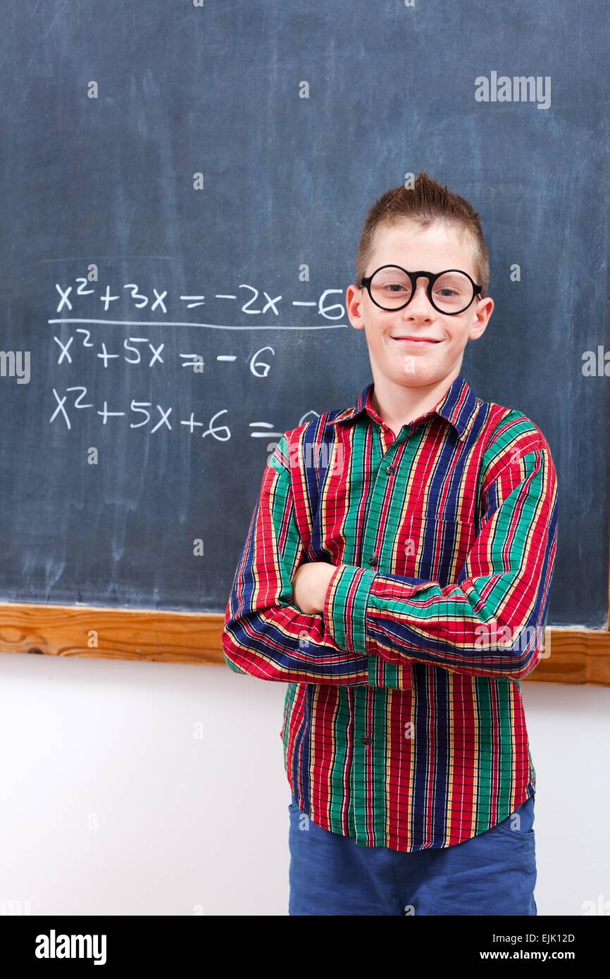Eminent math boy in glasses, standing in front of formulas Stock Photo ...