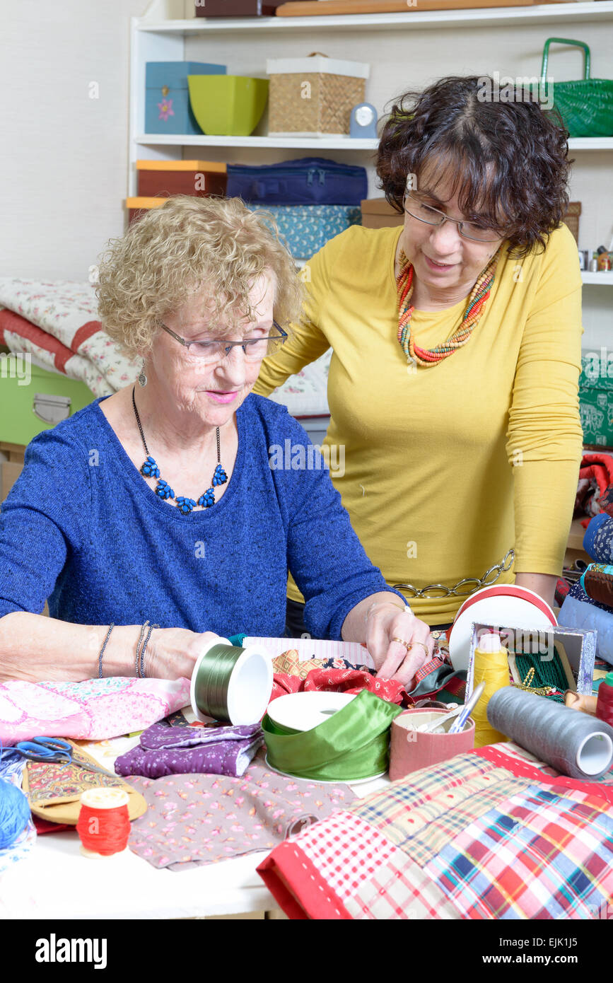 two women working on their patchwork in the workshop Stock Photo - Alamy