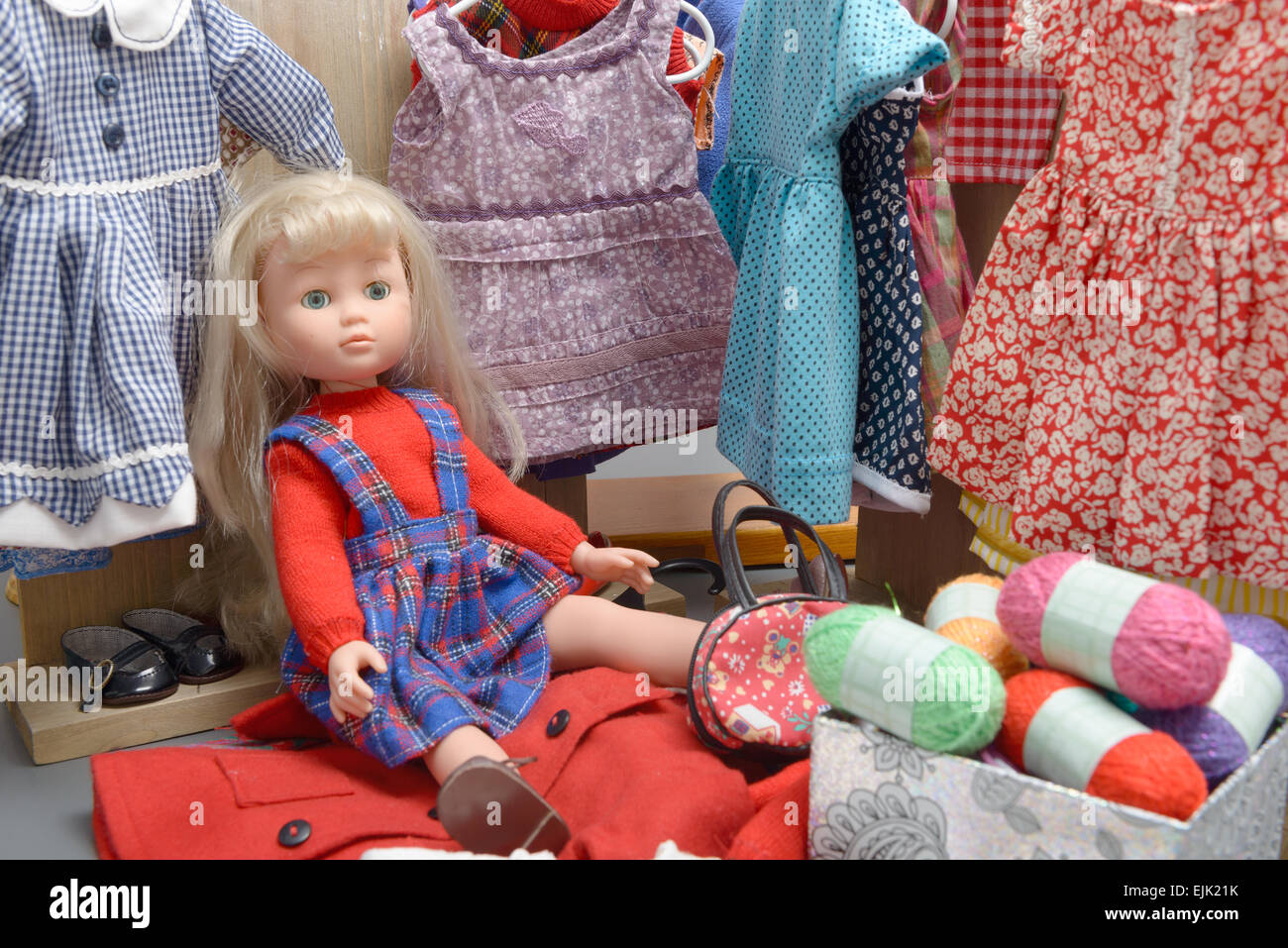 a blond toy doll with several dresses Stock Photo - Alamy