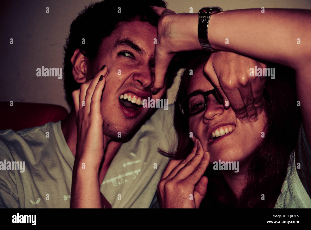 Two young people pulling faces Stock Photo - Alamy