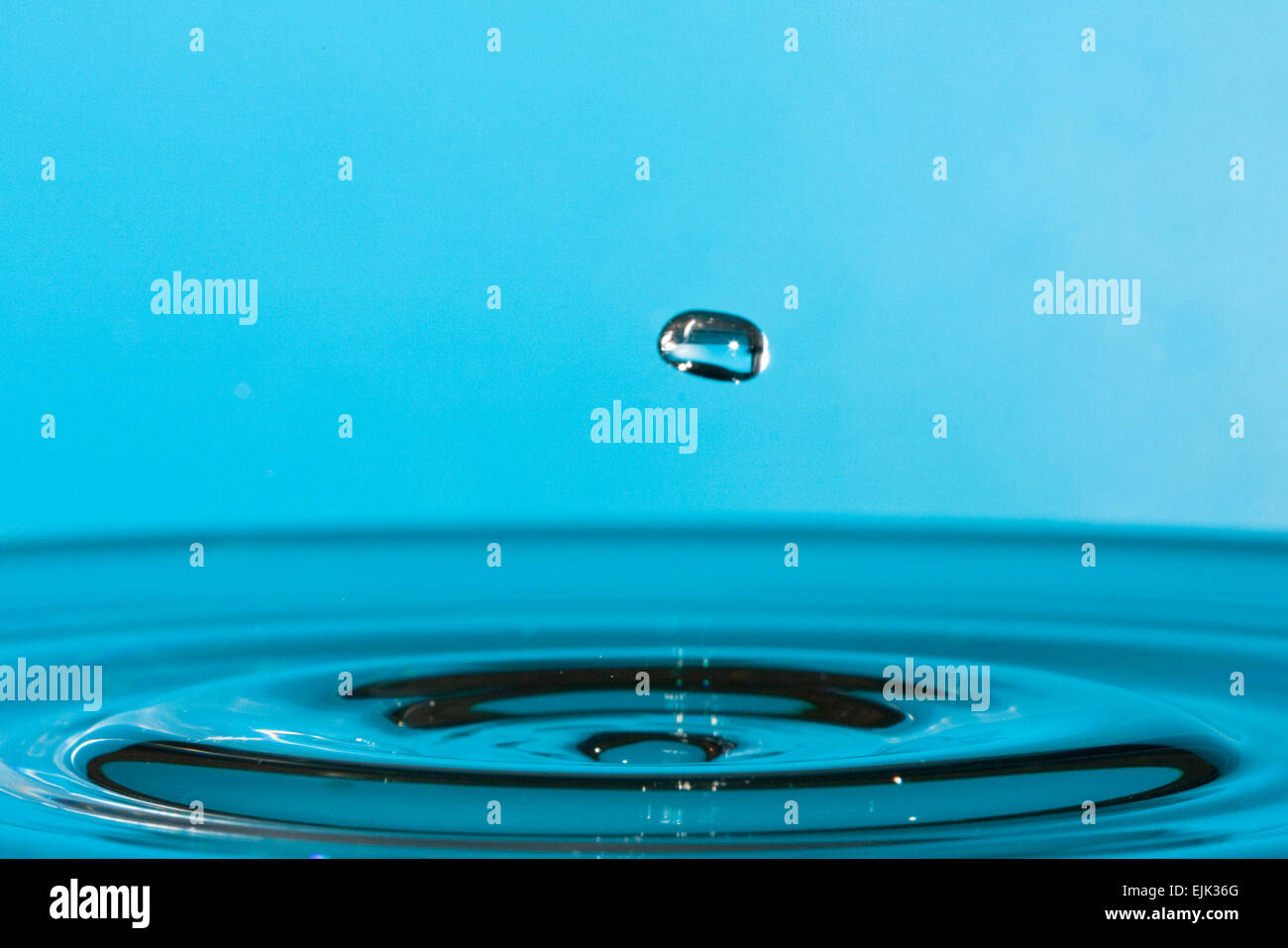Closeup of a floating blue water-drop Stock Photo - Alamy