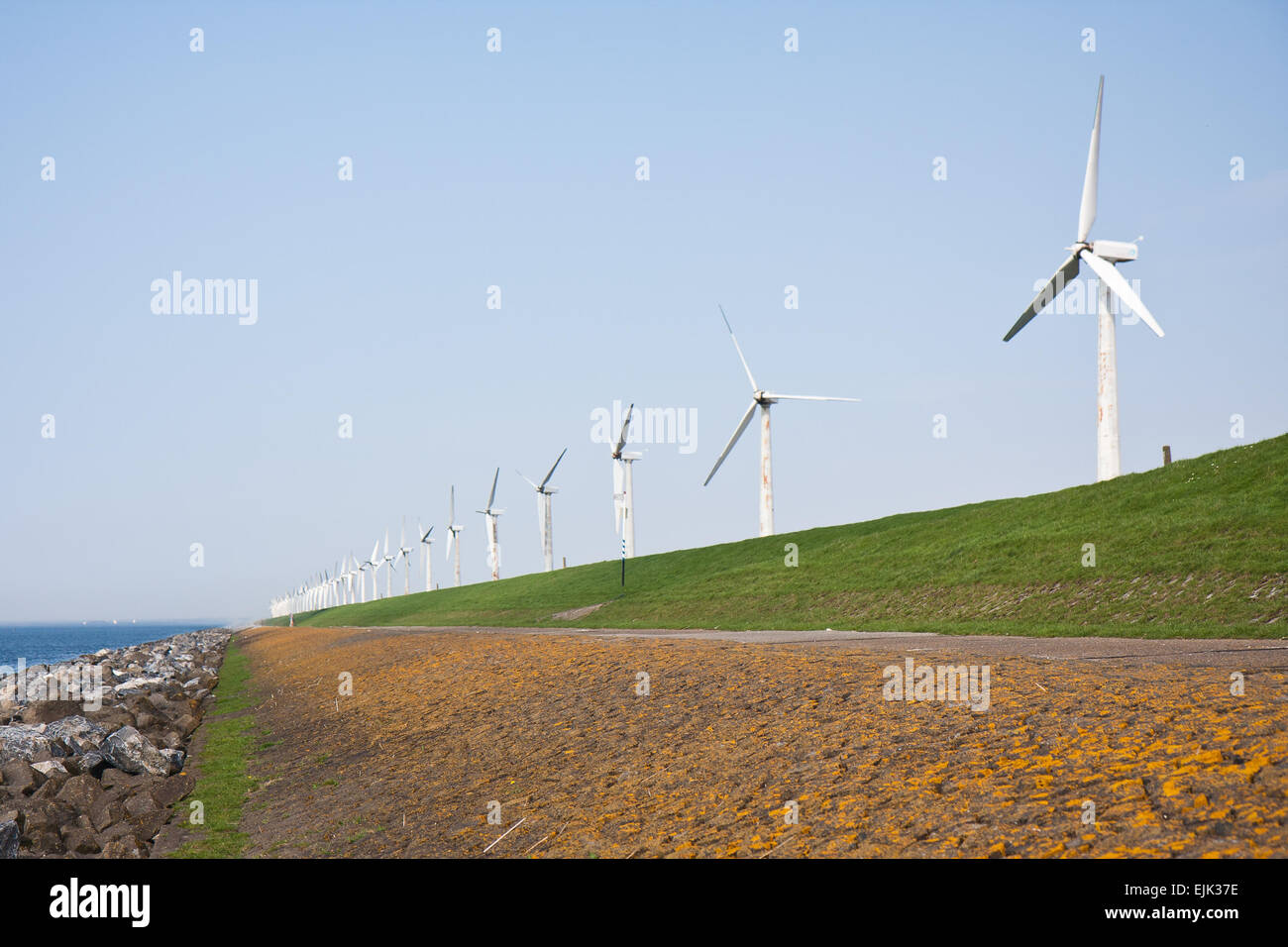 Windmills near the sea along a Dutch dike Stock Photo - Alamy