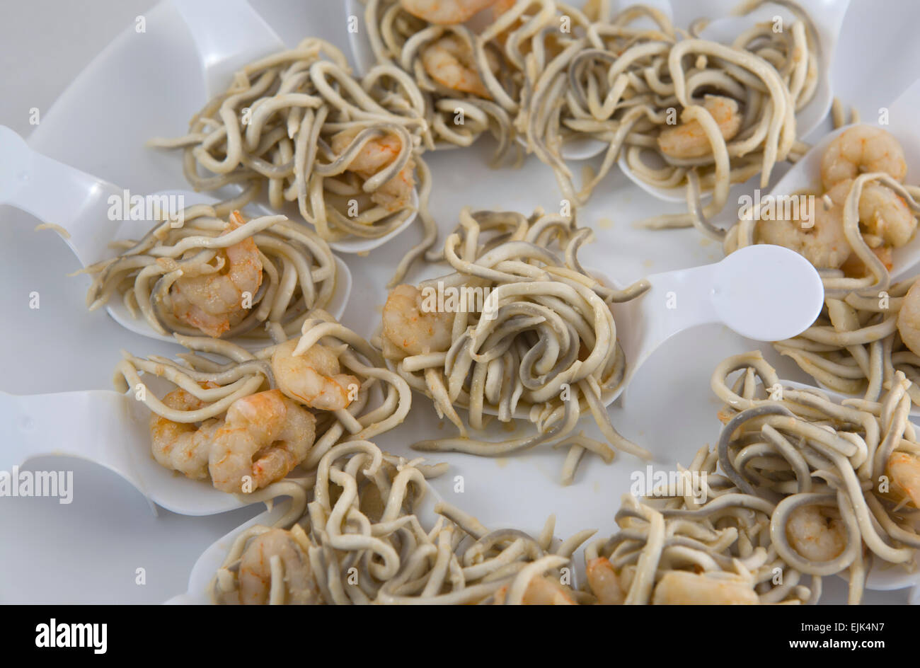 Eel and shrimp spoons with garlic, isolated over white background Stock ...
