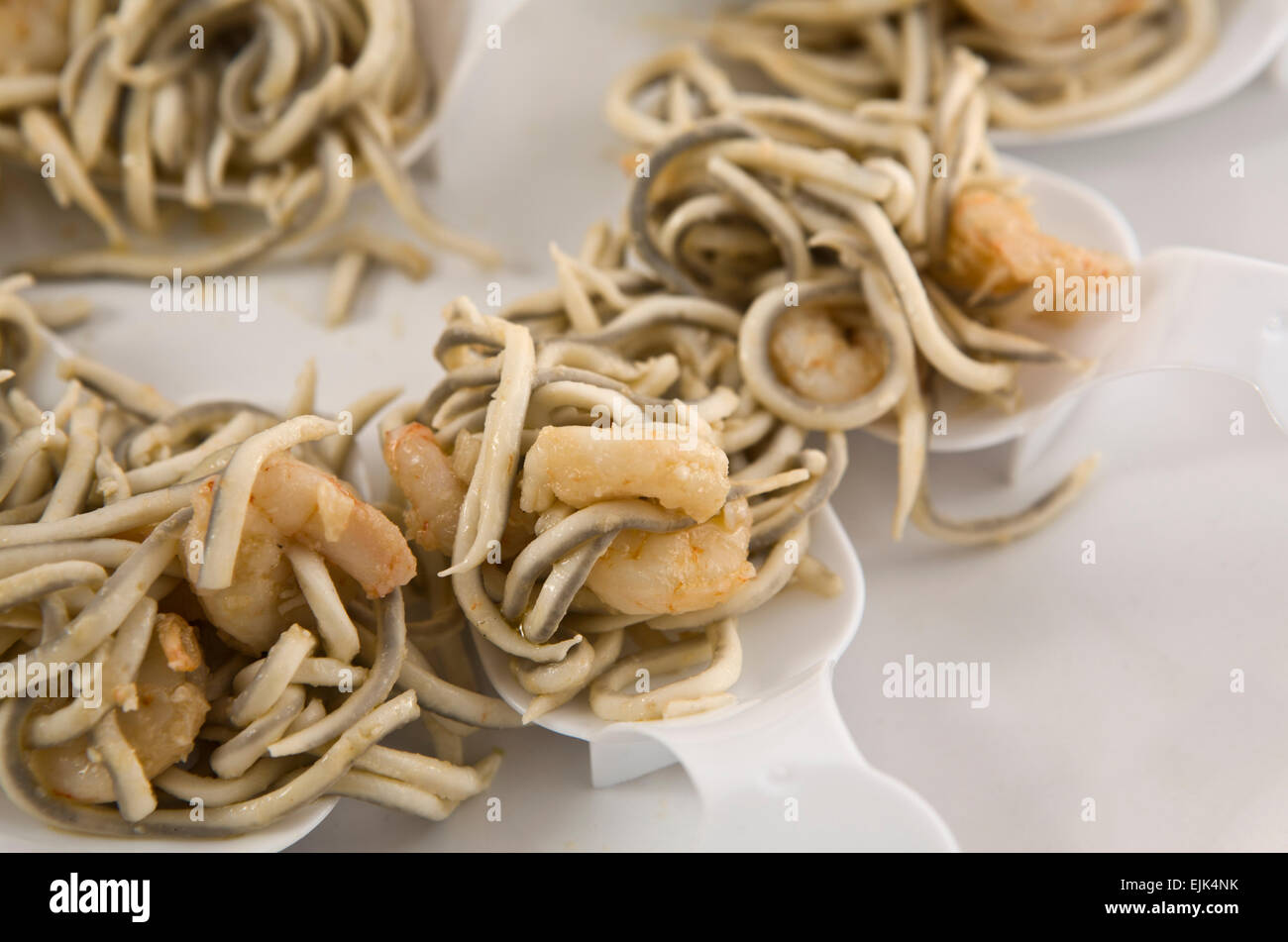 Eel and shrimp spoons with garlic, isolated over white background Stock ...