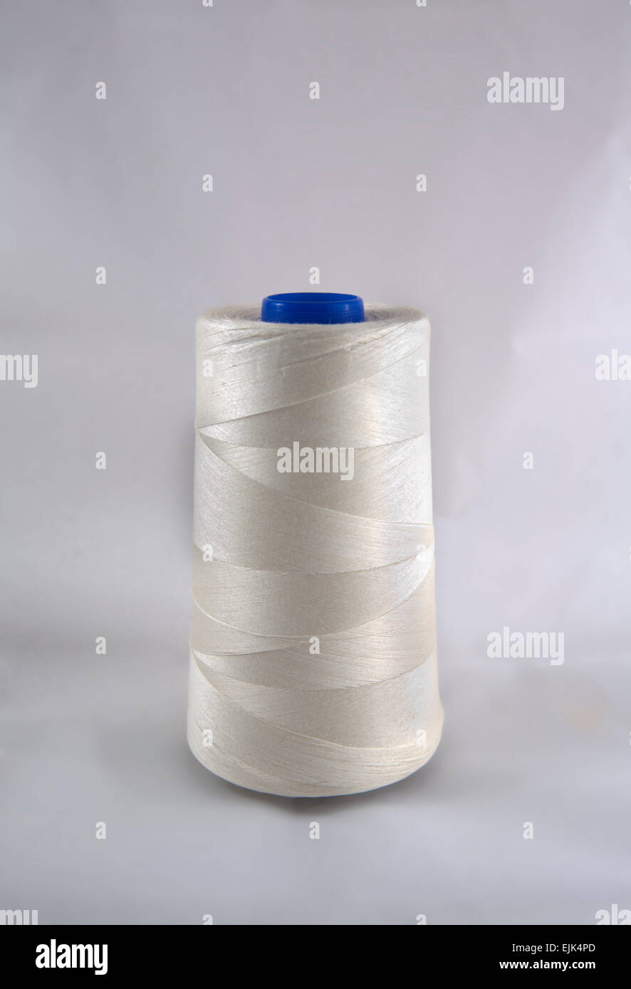 Cotton thread on spool isolated on white background Stock Photo - Alamy
