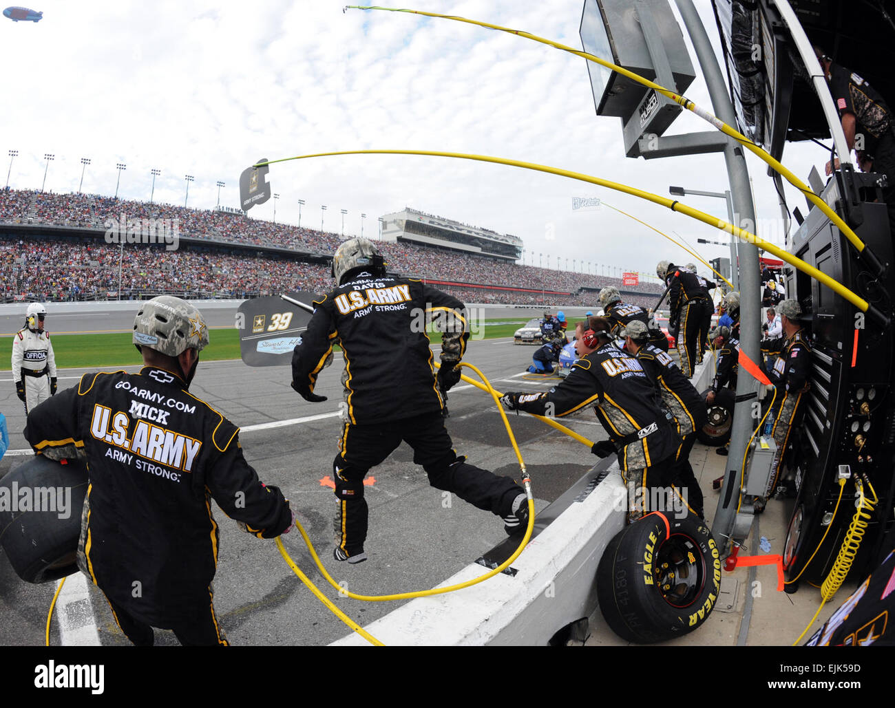 The U.S. Army Racing Team crew springs into position as driver Ryan ...