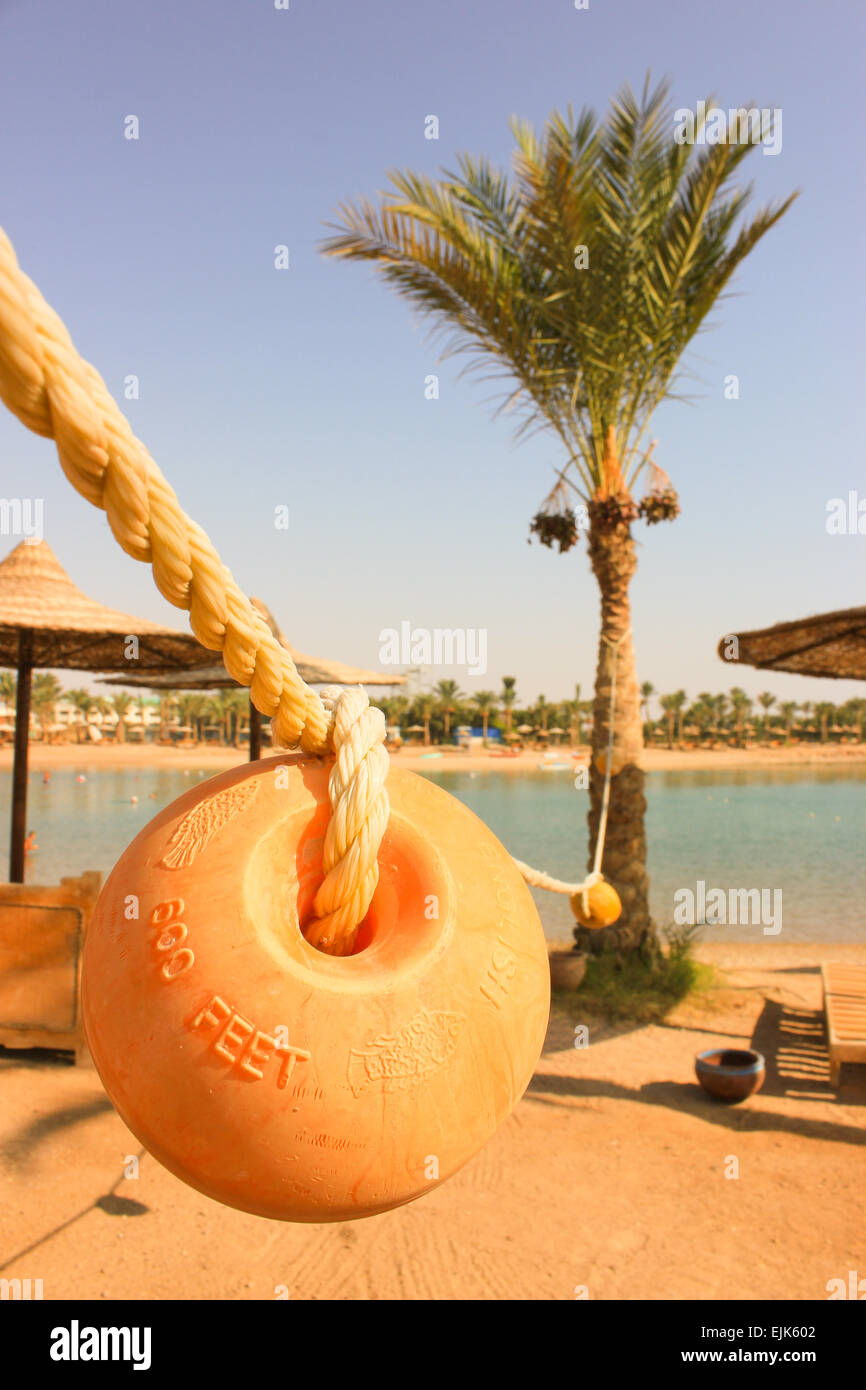 Floats on sun beach background. Buoys dry out between palm trees Stock ...
