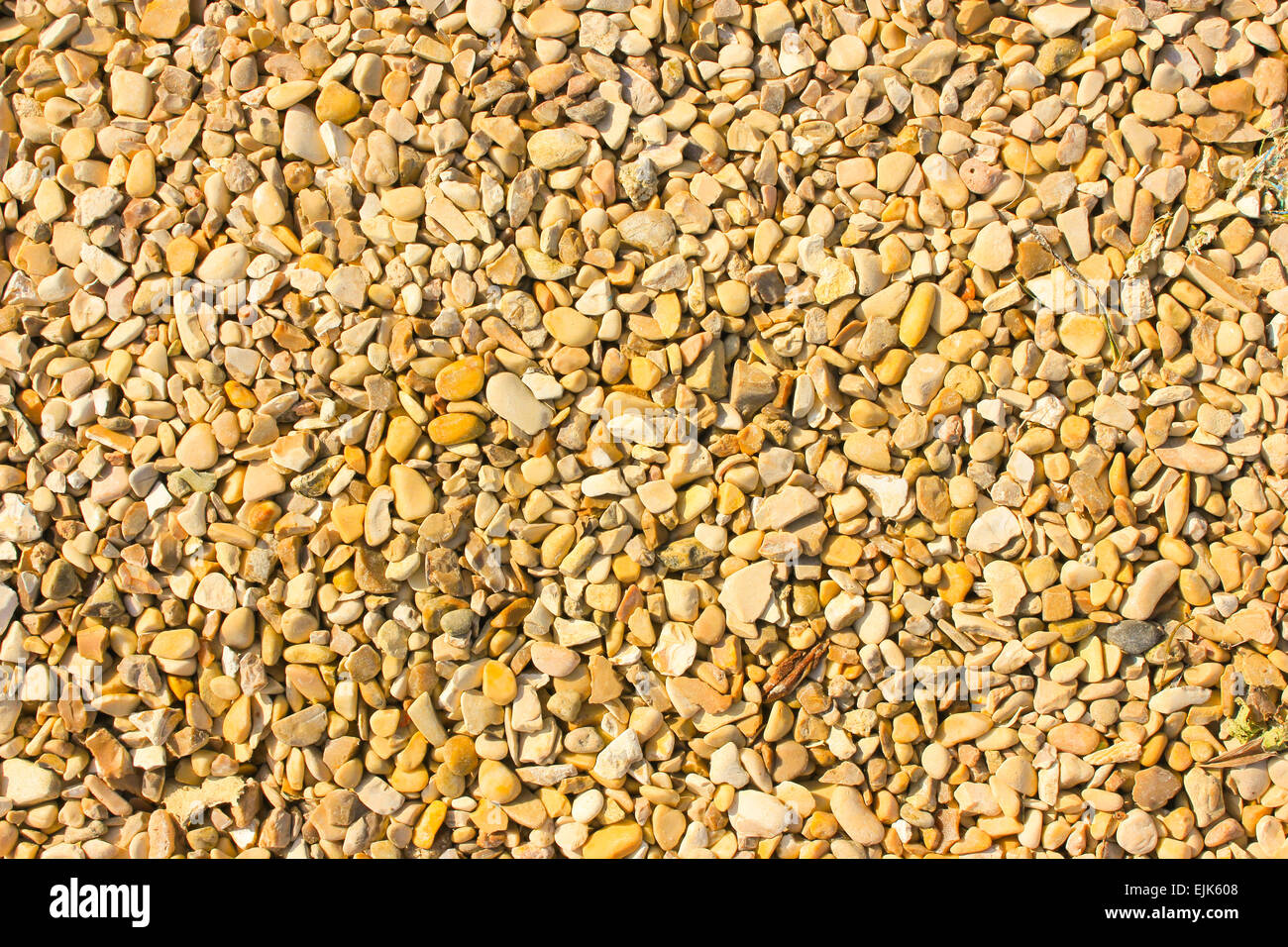 Pebble background at sun light. Stone texture Stock Photo - Alamy