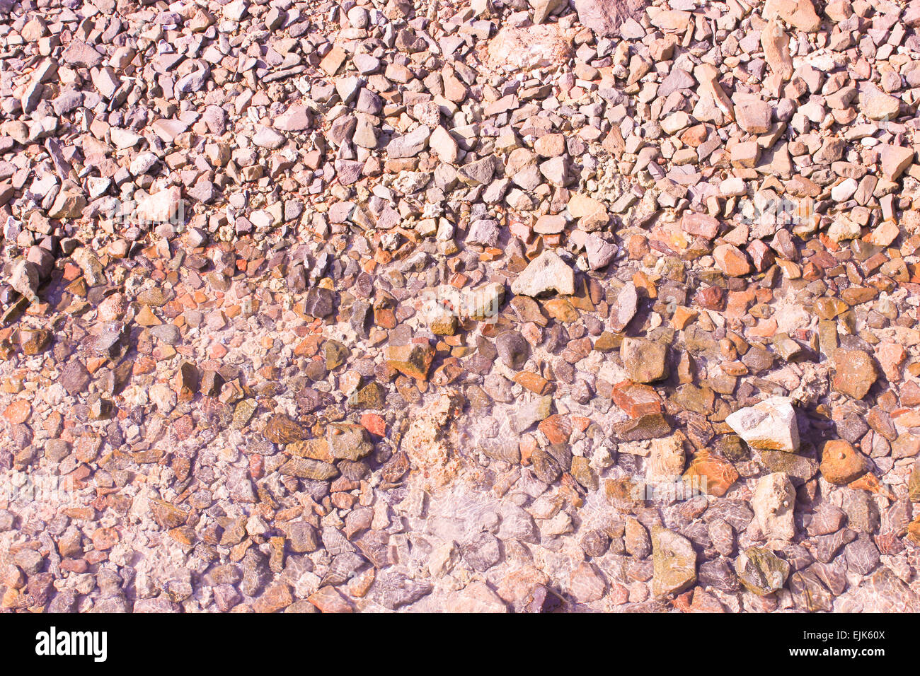 Pebble background at sun light. Stone texture Stock Photo - Alamy