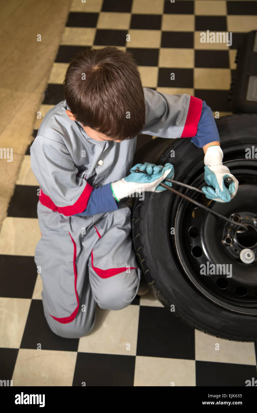 Boy in the auto repair shop Stock Photo - Alamy